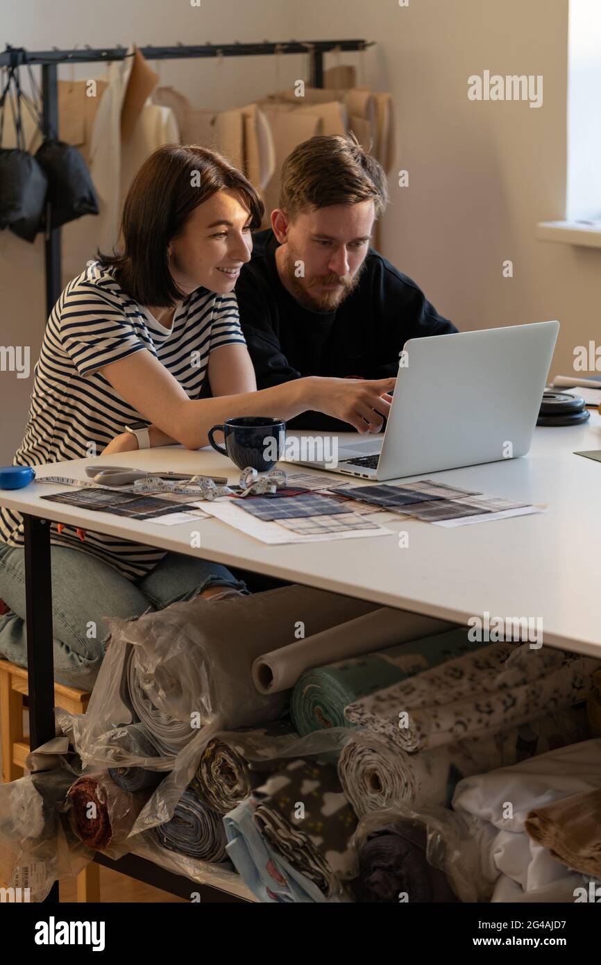 Fashion designers team work on new project in studio. Brainstorming of ...