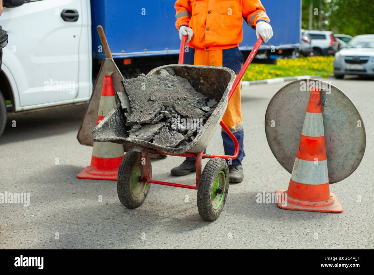 Trolley with asphalt. Road repair. Construction waste trolley. Repair ...