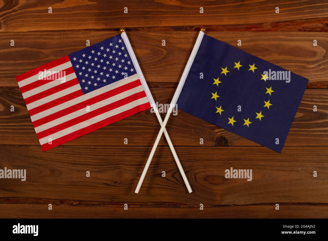 Flag of USA and flag of European Union crossed with each other. USA vs ...
