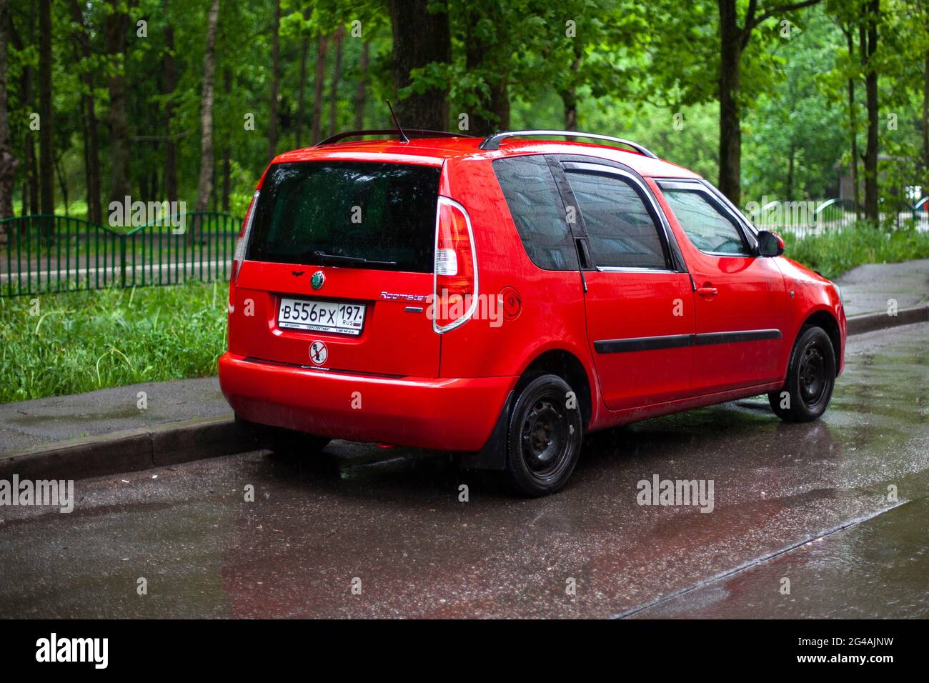 Red car in the parking lot. The car is on the road. Red family car ...