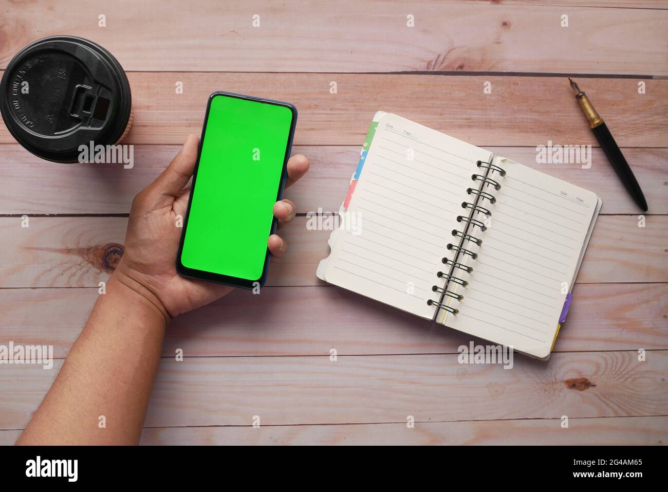 top view of man hand using smart phone on office desk Stock Photo - Alamy