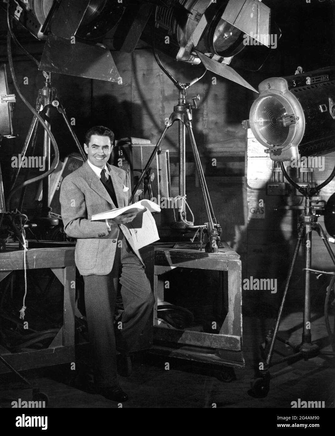 TYRONE POWER on set candid portrait surrounded by movie lights at ...