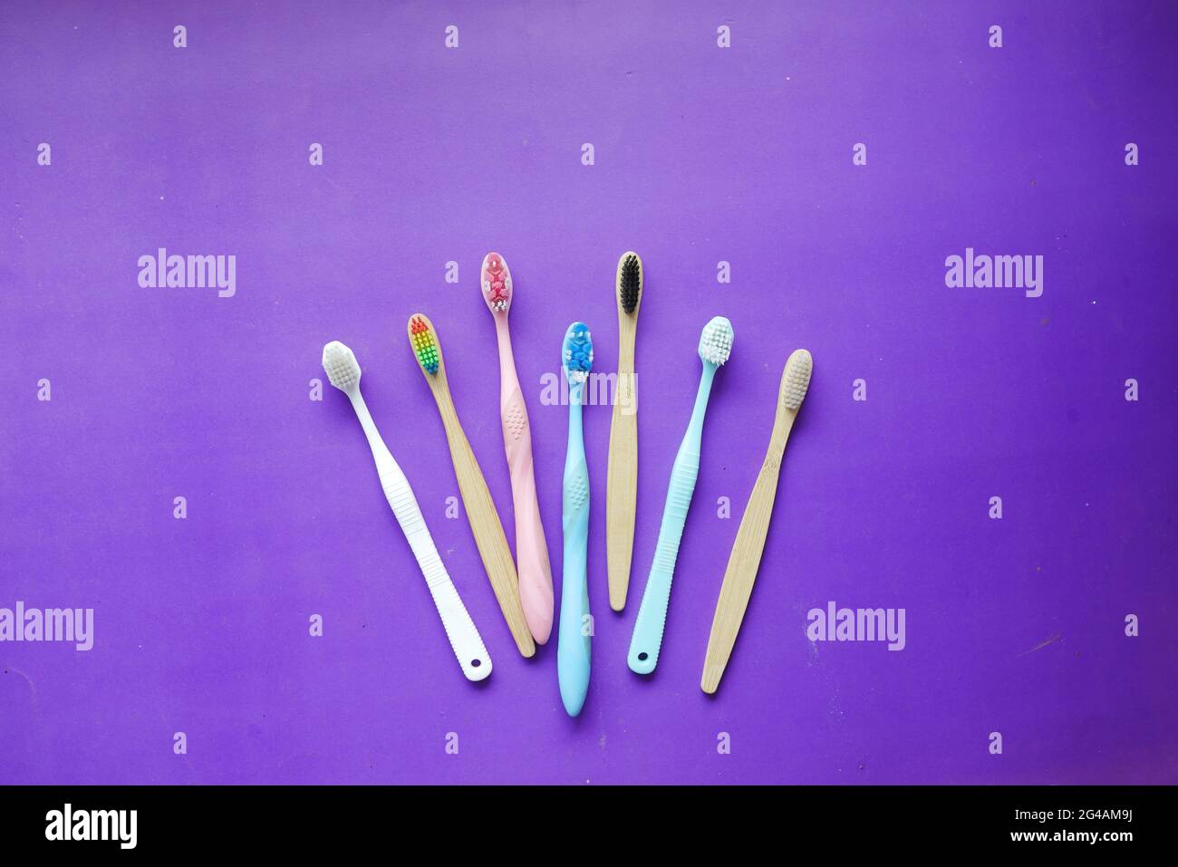 colorful toothbrushes on purple background , top view Stock Photo - Alamy