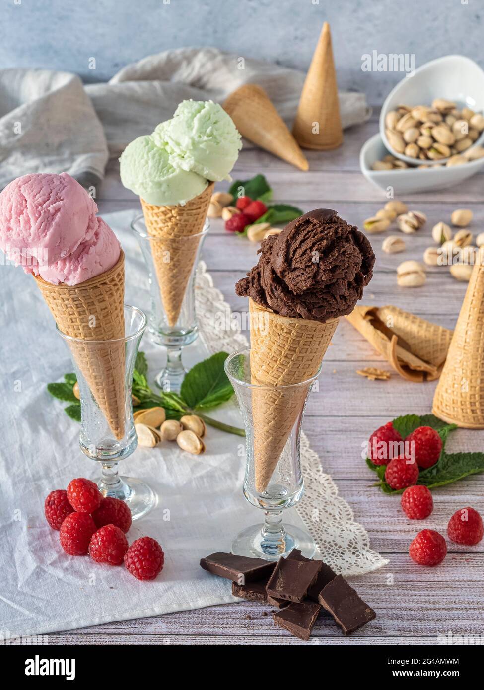 Close-up cones with scoops of delicious raspberry, cherry, pistachio ...