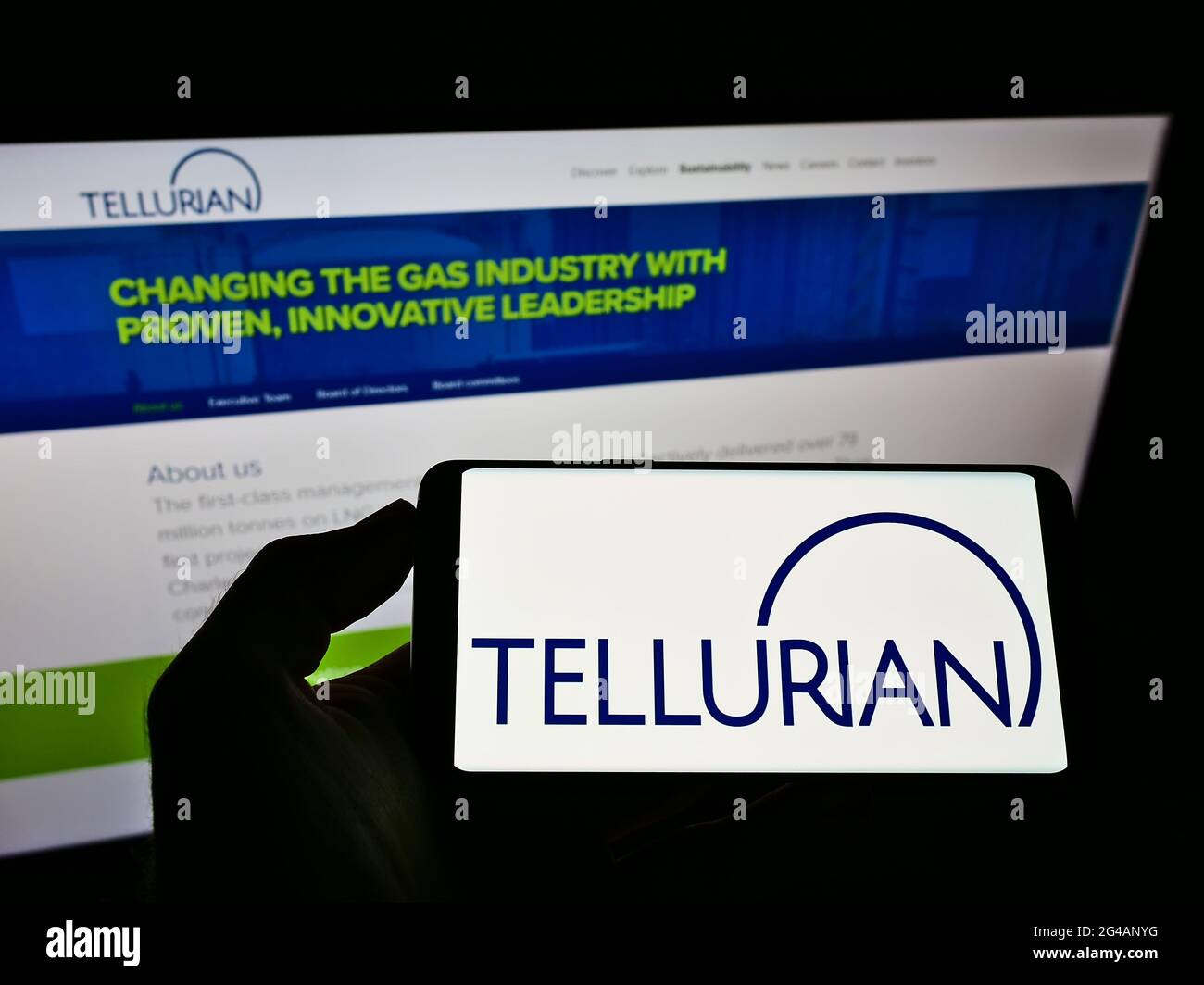 Person holding mobile phone with logo of American natural gas company ...
