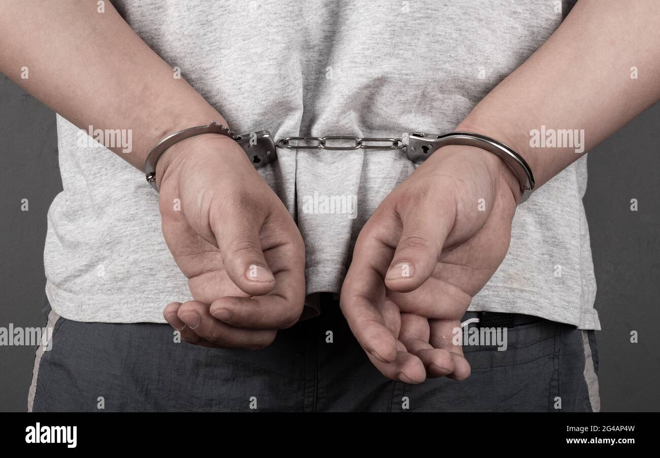 detention in a crime, man hand in handcuffs Stock Photo - Alamy