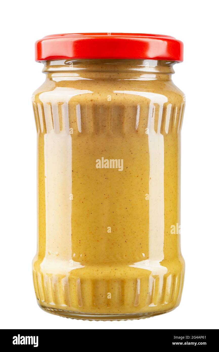 Mustard in a transparent glass jar with a closed red metal lid isolated ...