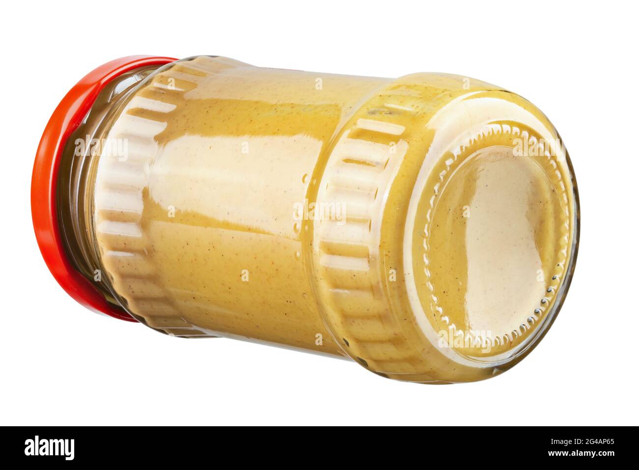 Mustard in a transparent glass jar with a closed red metal lid isolated ...