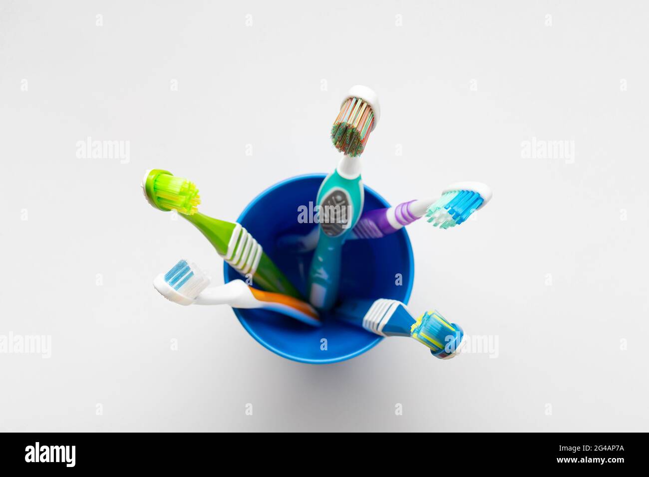 Toothbrushes in a plastic cup on a white background. Concept toothbrush ...
