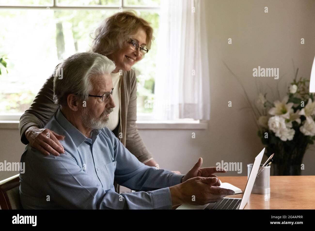 Happy old man and woman use laptop at home Stock Photo - Alamy