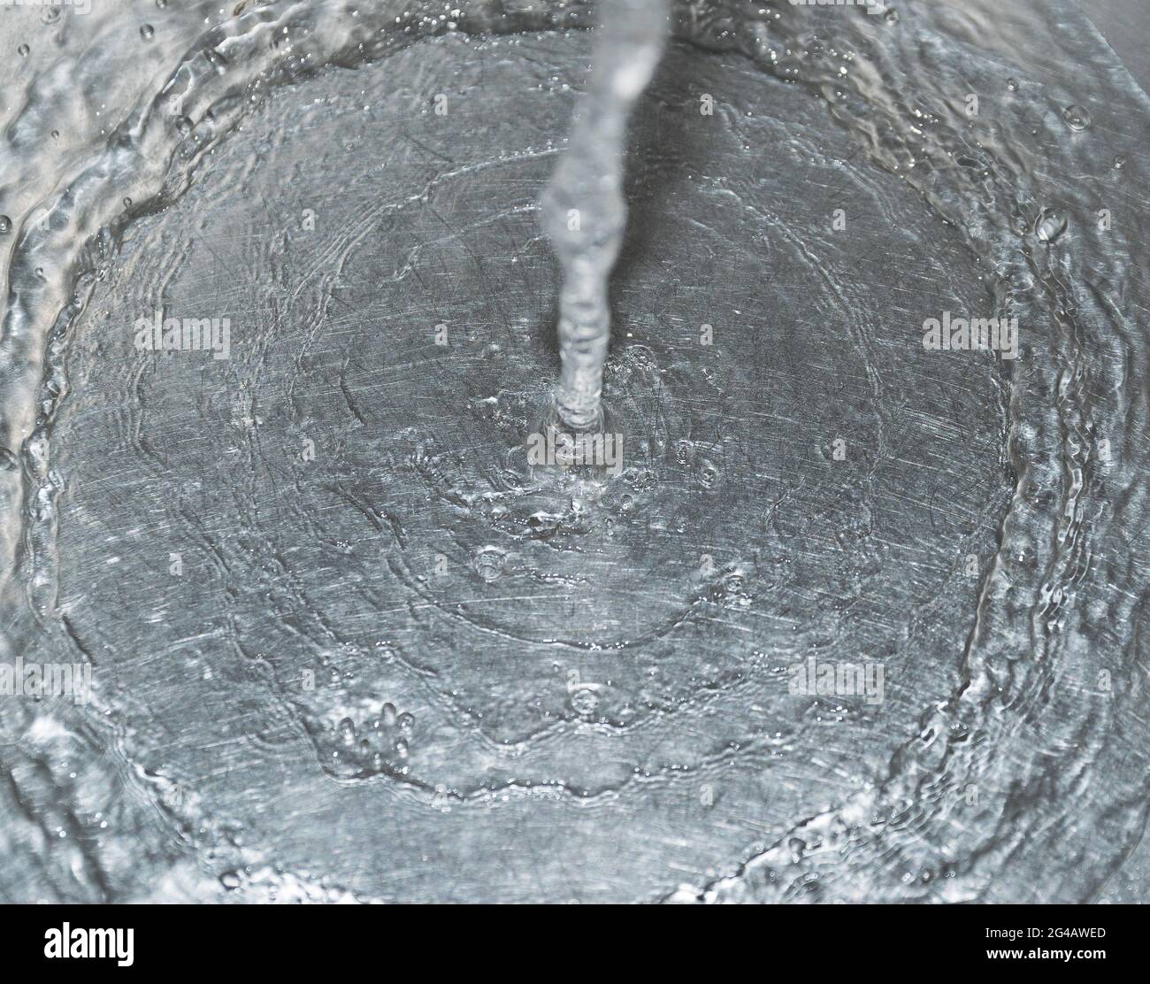 Water flowing down the hole in a kitchen sink. Selective focus Stock ...