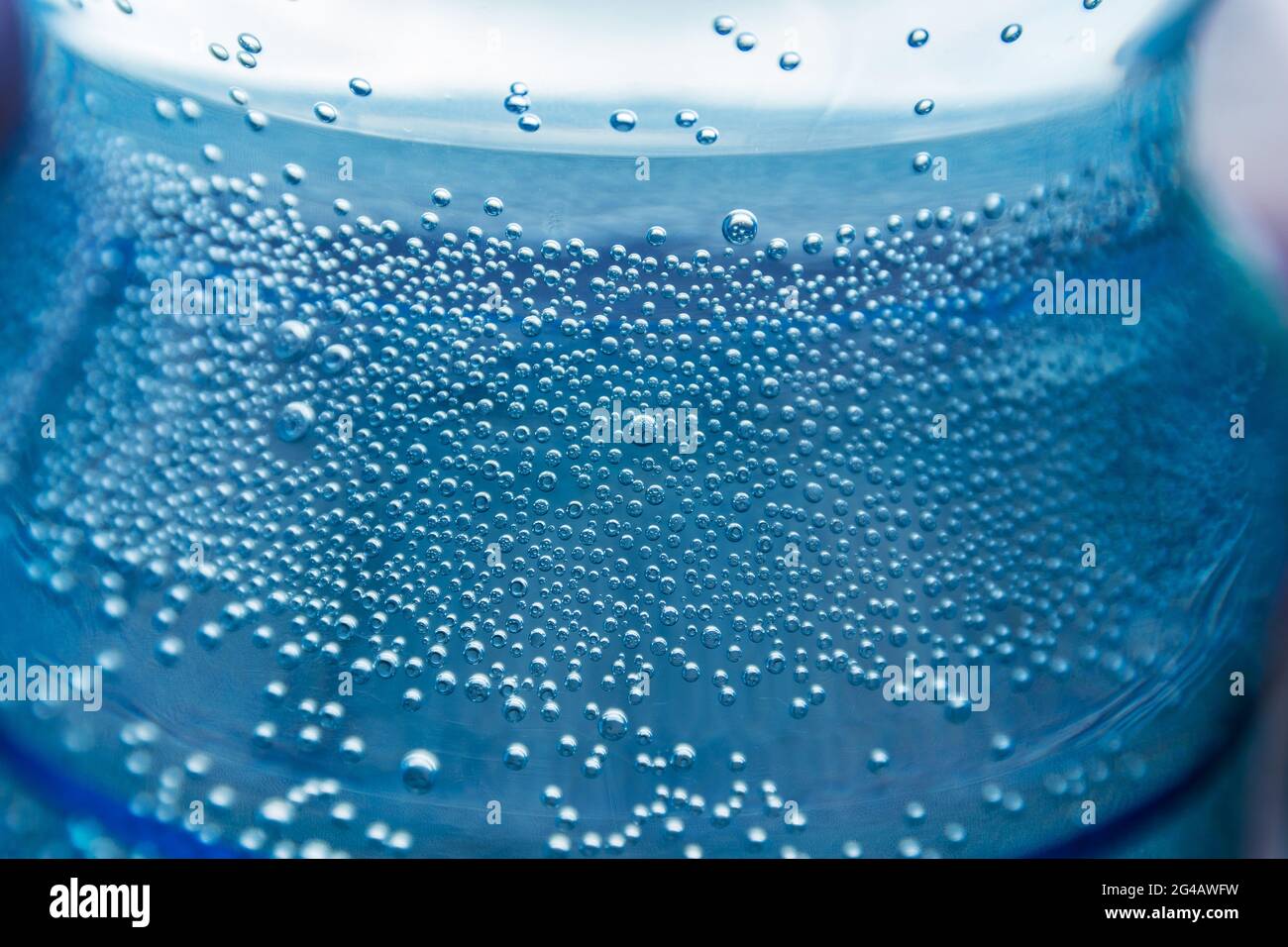 Oxygen bubbles in the bottle with water or drink. Selective focus on ...