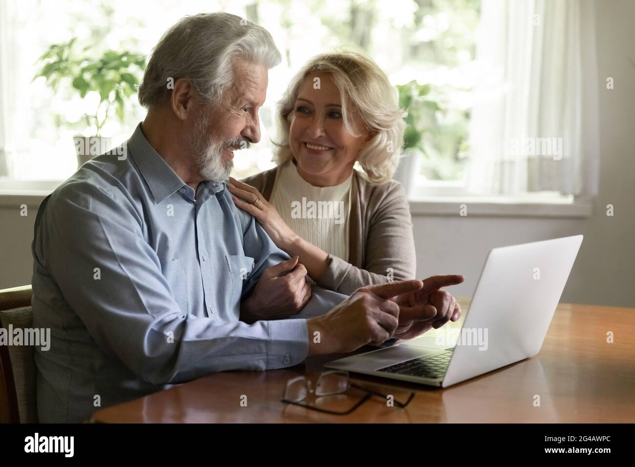 Happy old Caucasian couple use computer together at home Stock Photo ...