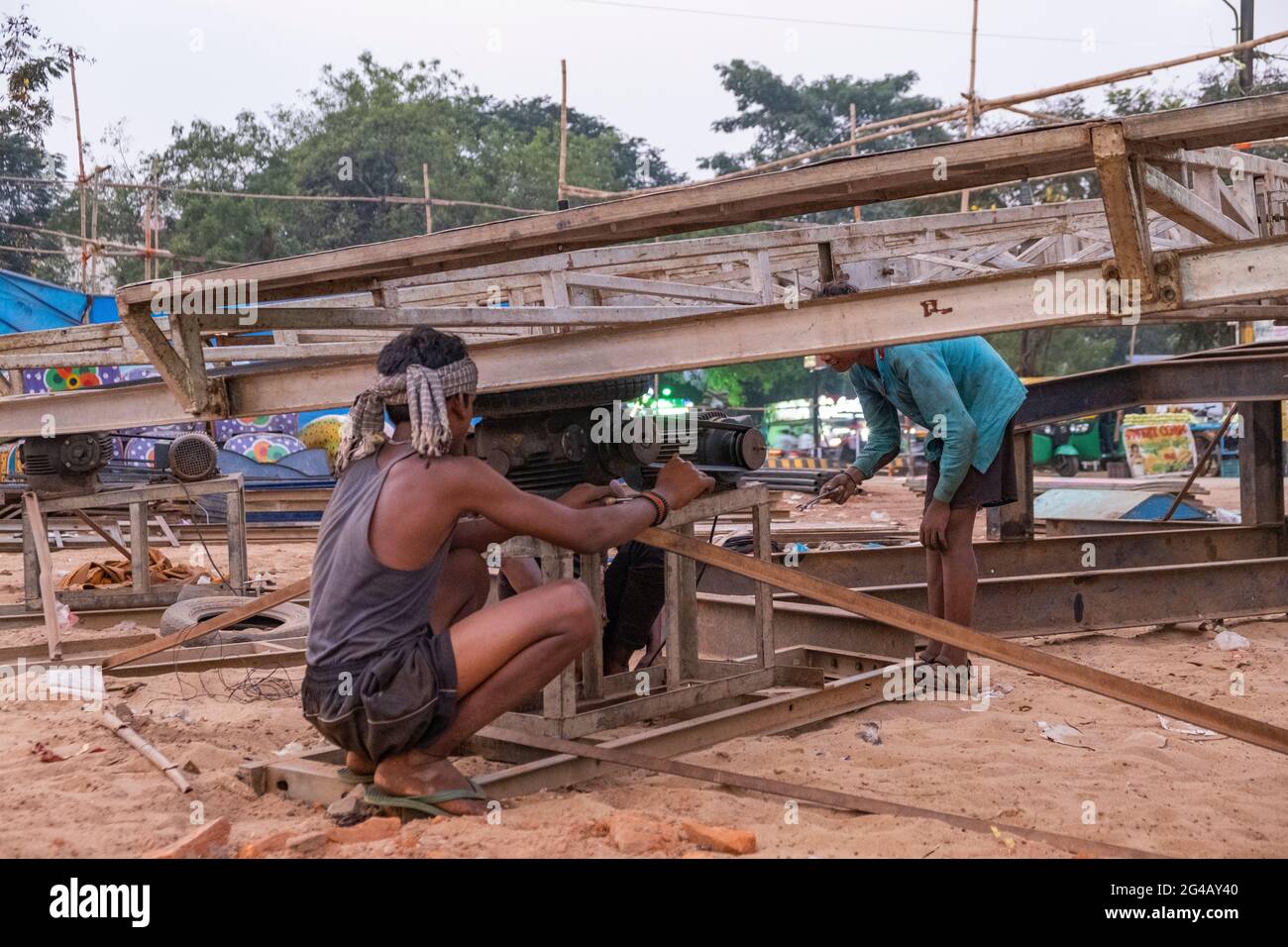 Workers dismantling various fair ground rides Stock Photo - Alamy