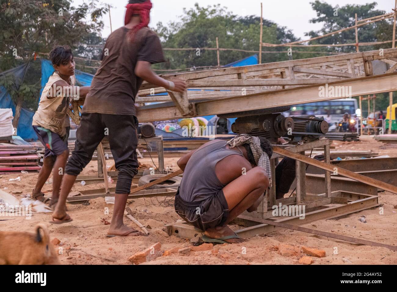 Workers dismantling various fair ground rides Stock Photo - Alamy