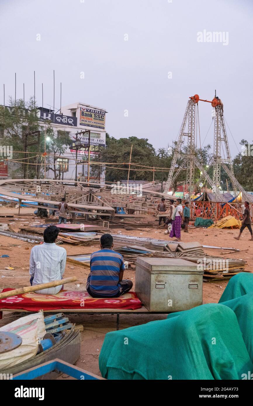 Workers dismantling various fair ground rides Stock Photo - Alamy