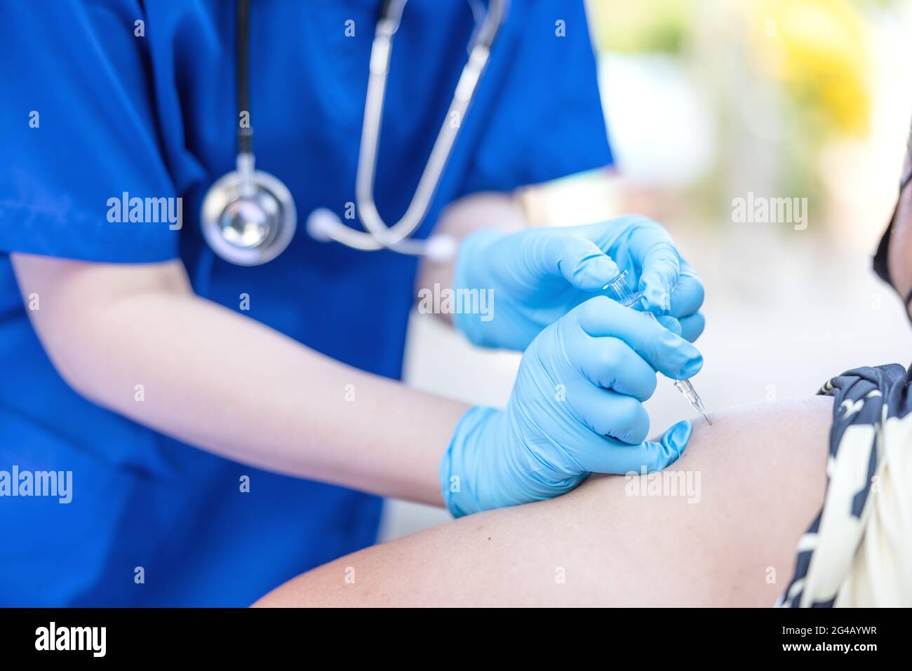 Woman doctor holding syringe make injection to patient in medical ...