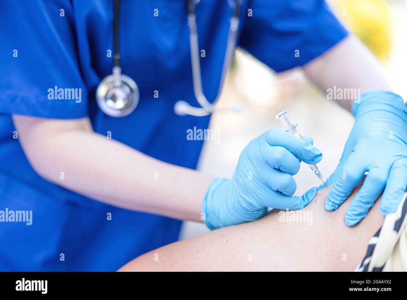 Woman doctor holding syringe make injection to patient in medical ...