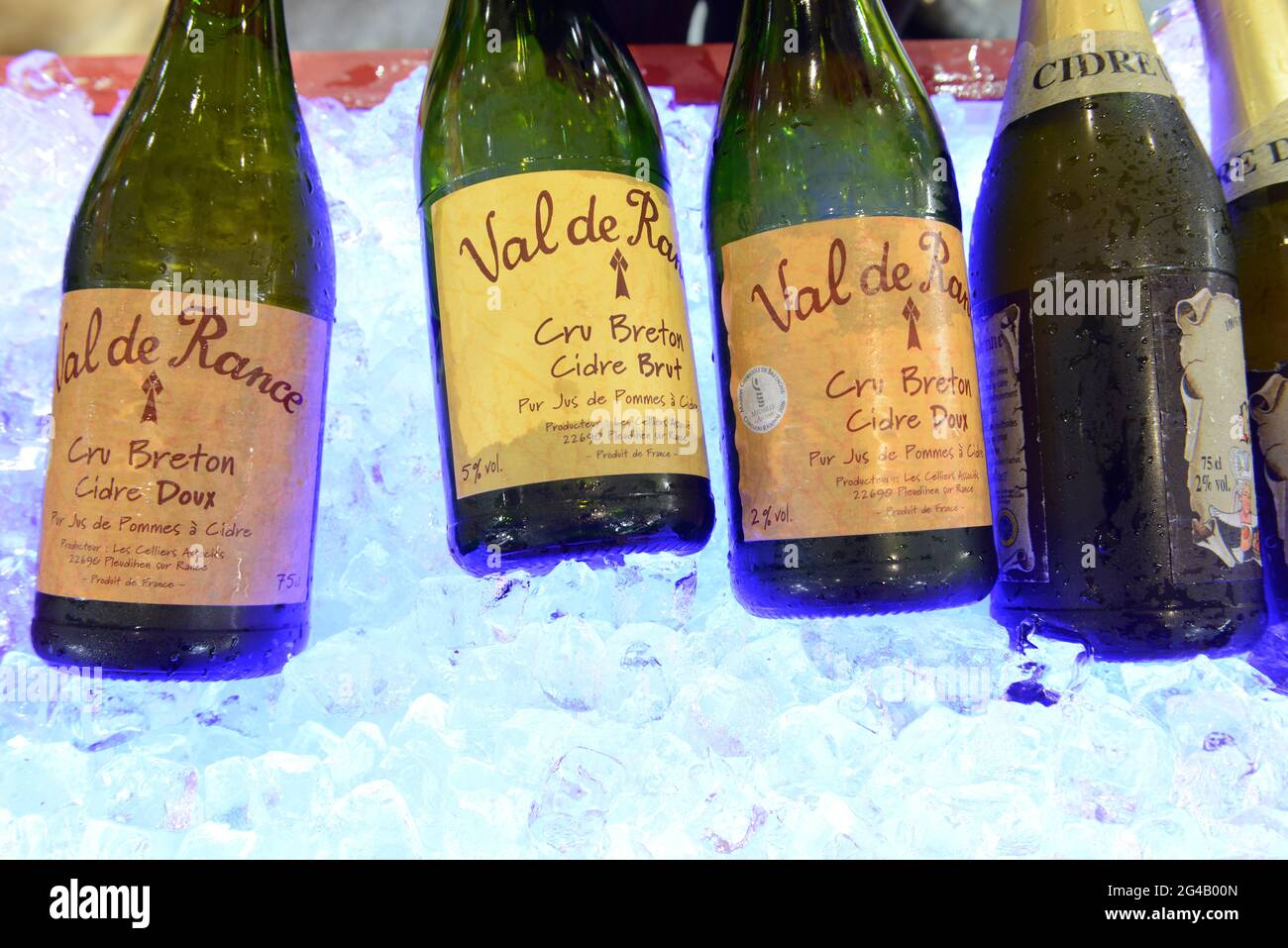 Bottles of cider from France are displayed chilling in a vat of ice at ...