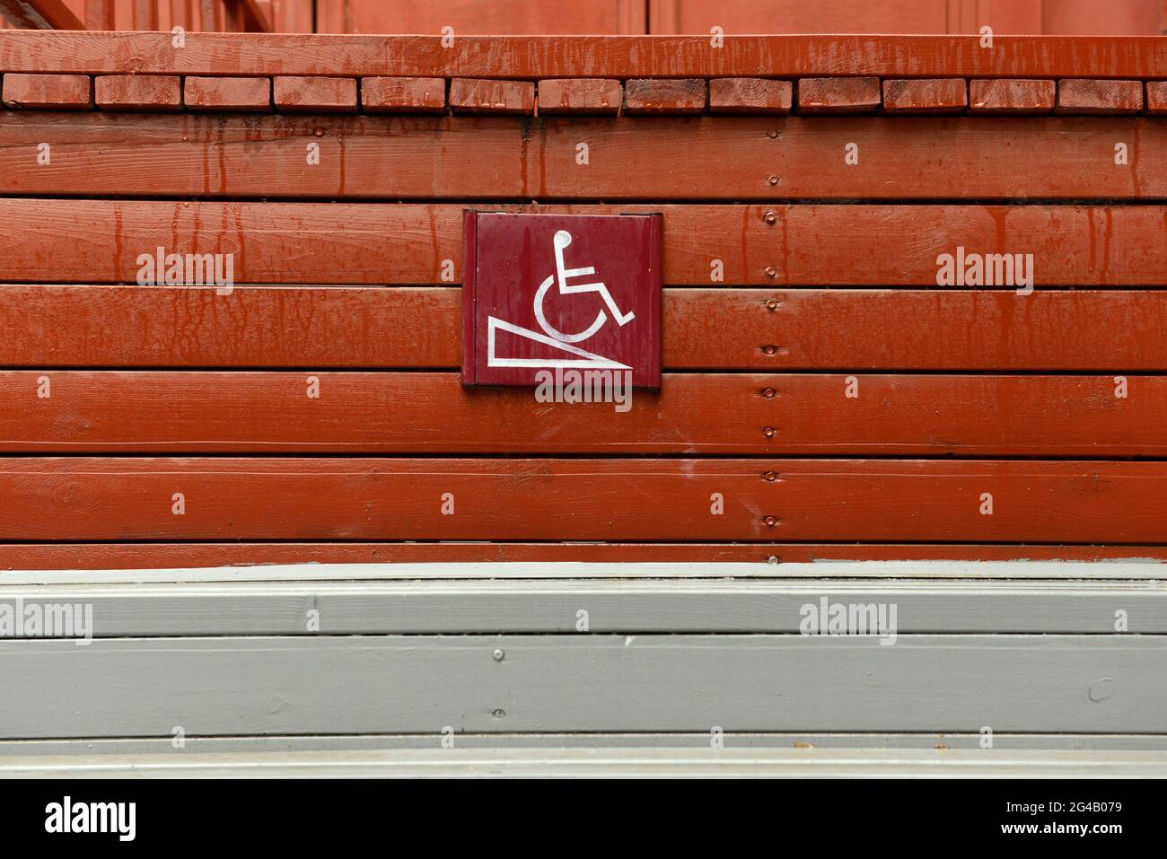 A sign indication the location of an accessible ramp for wheelchair ...