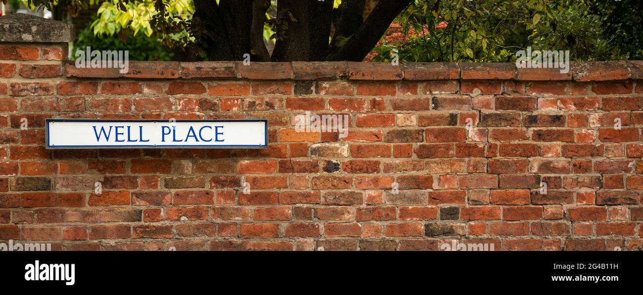 Well Place sign on brick wall - concept image Stock Photo - Alamy