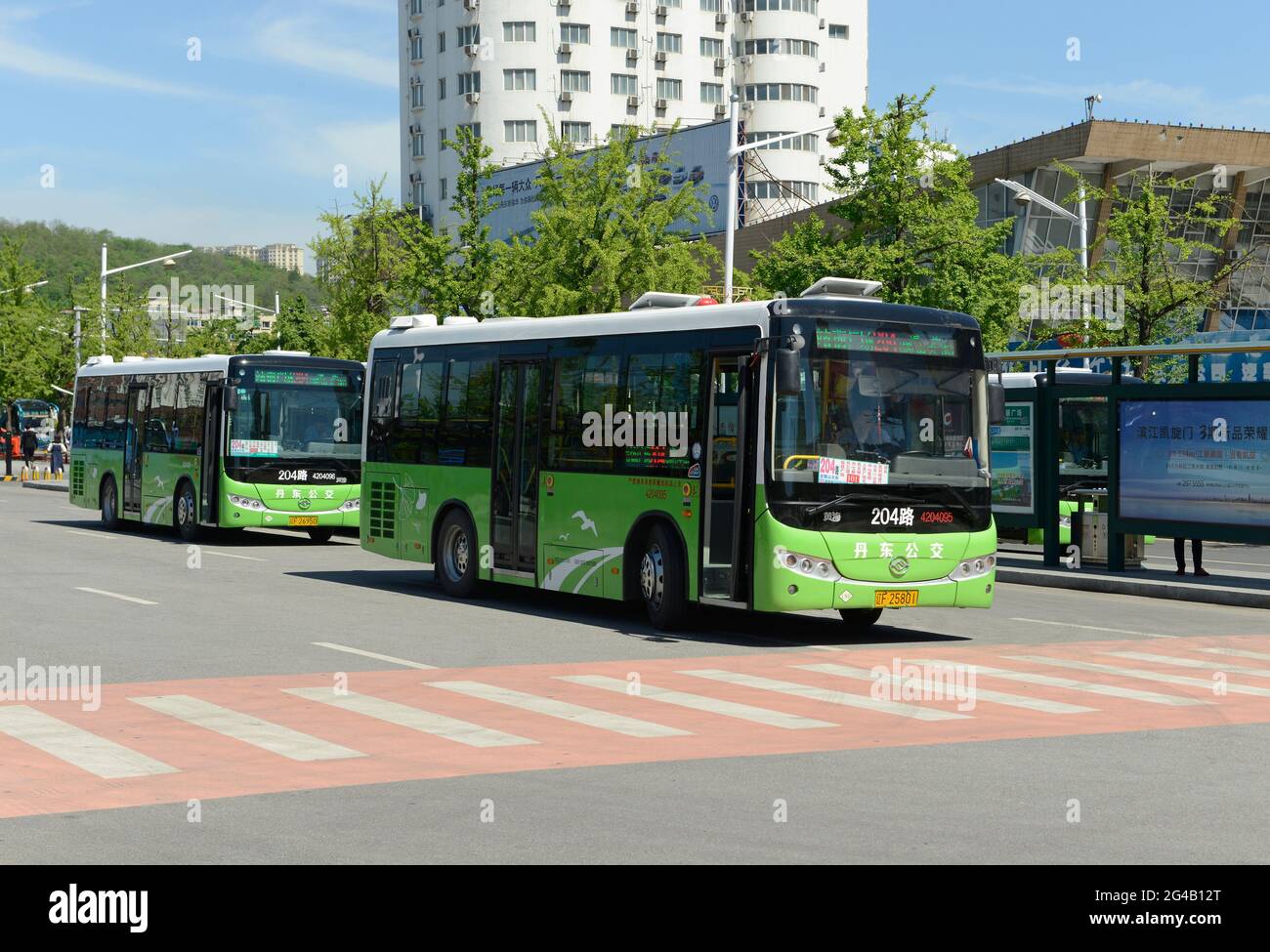 To city buses at the railway station bus stop in Dandong city, China ...