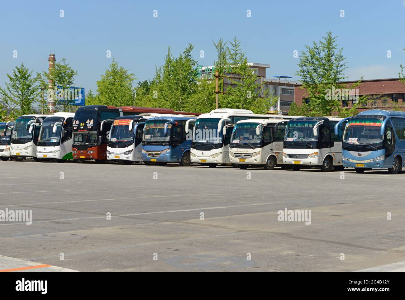 Buses and coaches at the railway station bus depot in Dandong city ...