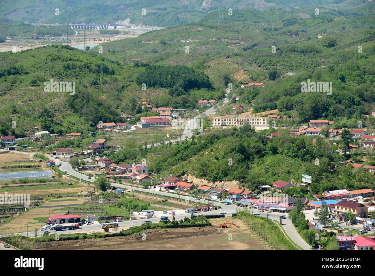 View of houses, farms and hills to the north of the Yalu river near ...