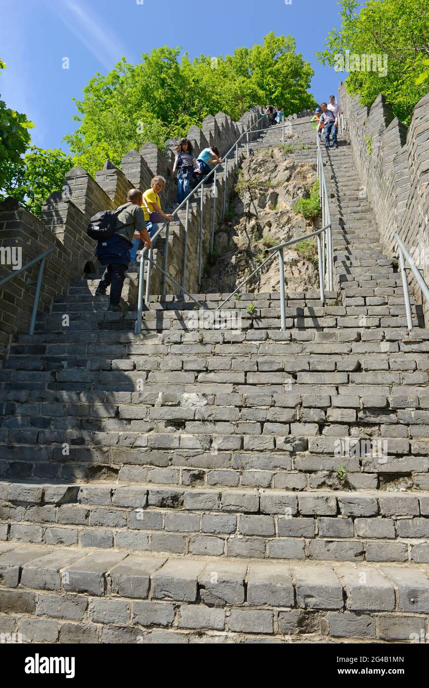 Visitors climb the steep steps of the great wall at Hushan on the ...