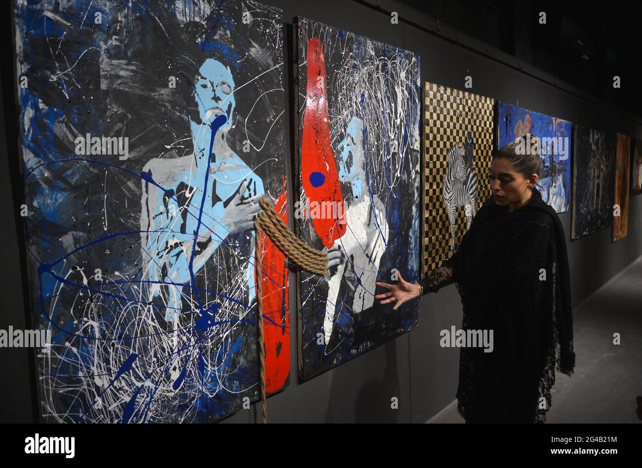 Pakistani visual artist Amna Butt gives tour to guests of her visual art hand made - painting ...