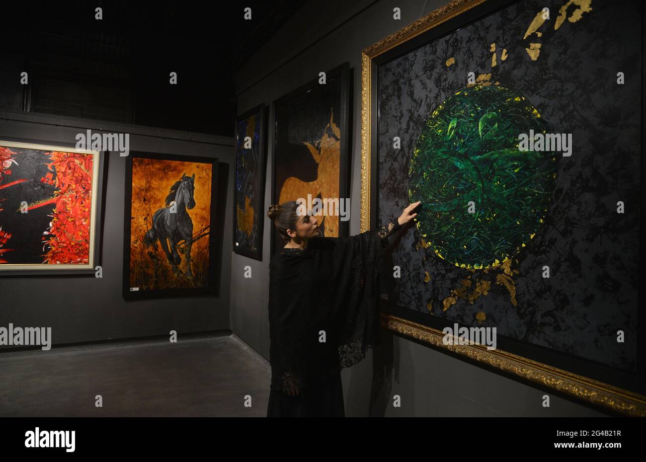 Pakistani visual artist Amna Butt gives tour to guests of her visual art hand made - painting ...