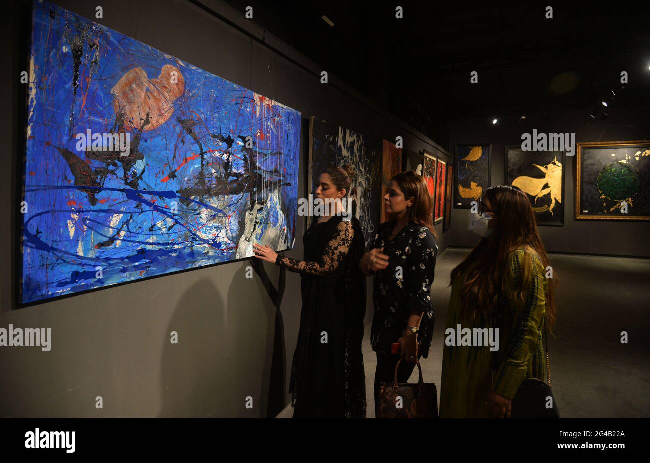 Pakistani visual artist Amna Butt gives tour to guests of her visual art hand made - painting ...