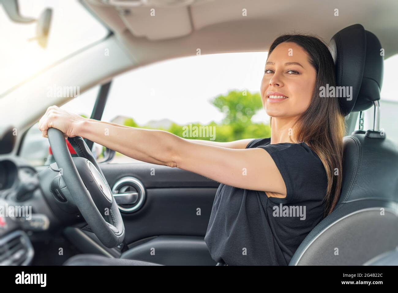 Beautiful young woman driving a car Stock Photo - Alamy