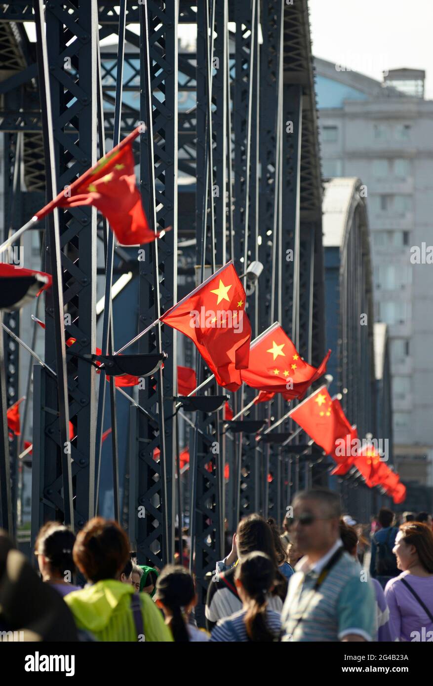 Many visitors on the old, bomb-damaged, bridge across the Yalu river ...