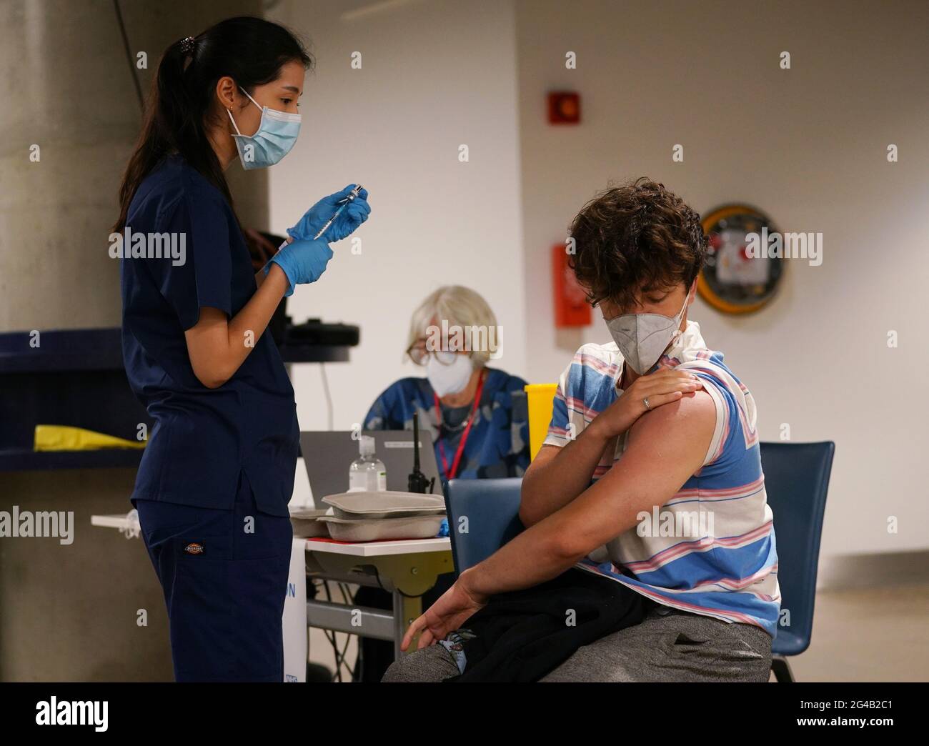 Humphrey Vocadlo, aged 20, receives a Pfizer BioNTech COVID-19 vaccine ...