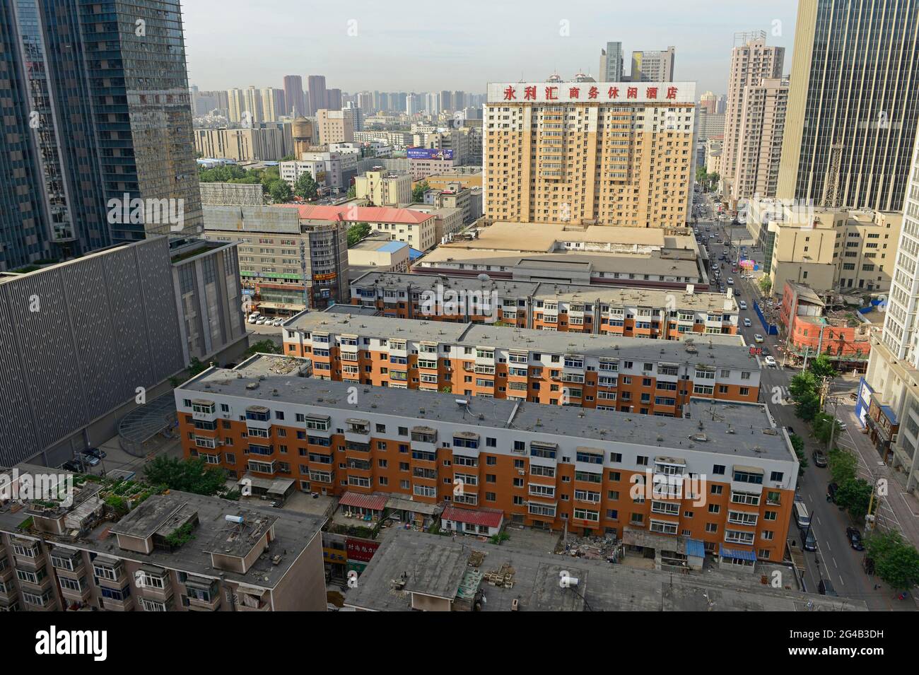 Older apartment building surrounded by newer apartment buildings ...