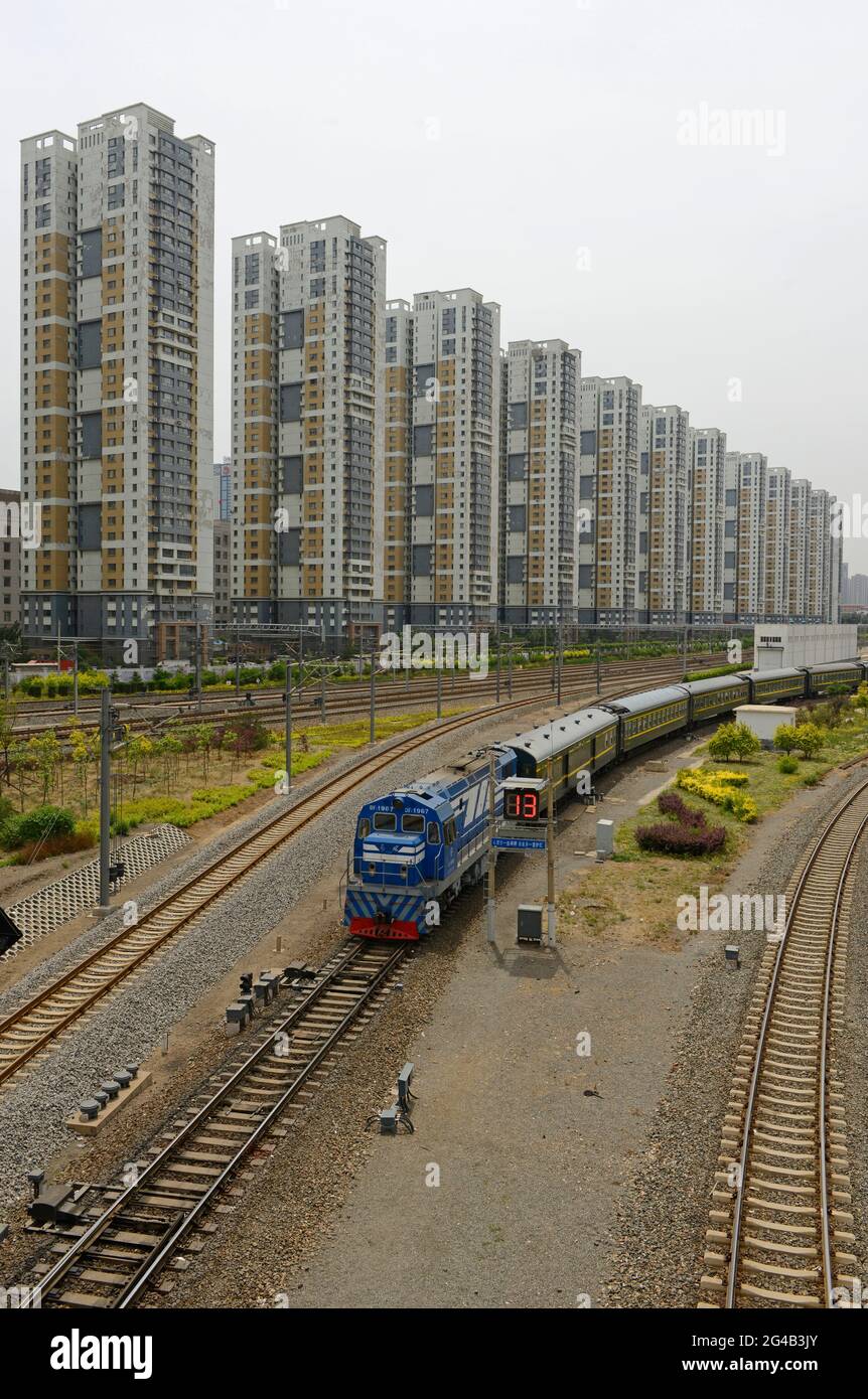 A locomotive shunts a train of carriages from the sidings to the ...