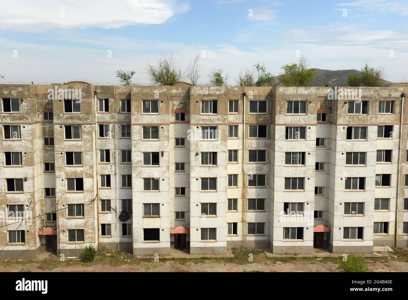 Empty and derelict apartment blocks by the railway line in Hebei ...