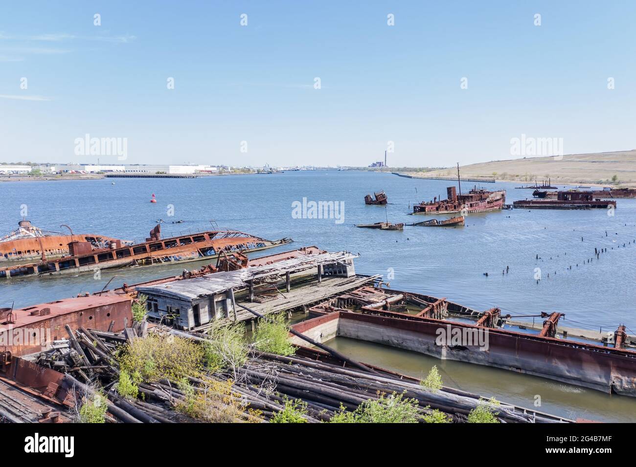 Aerial of buildings with a boat graveyard in the background Stock Photo ...