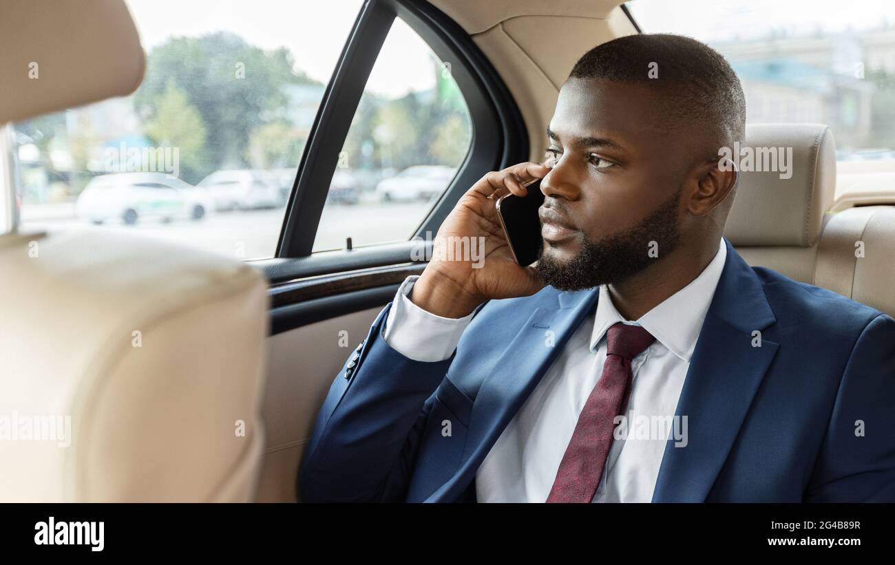 Pensive black manager going to office, having phone conversation Stock ...