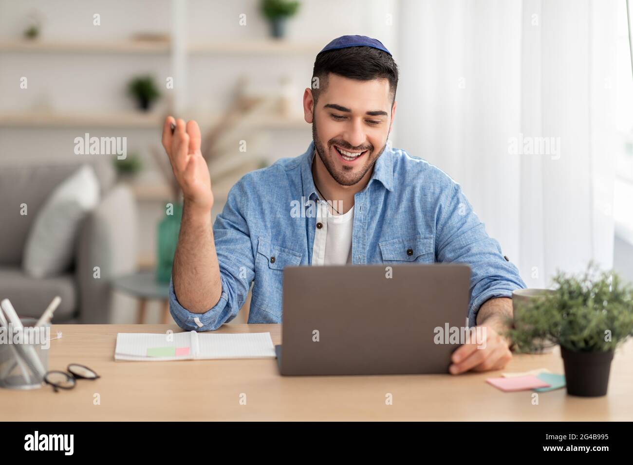 Smiling israeli man working on laptop computer at home Stock Photo - Alamy