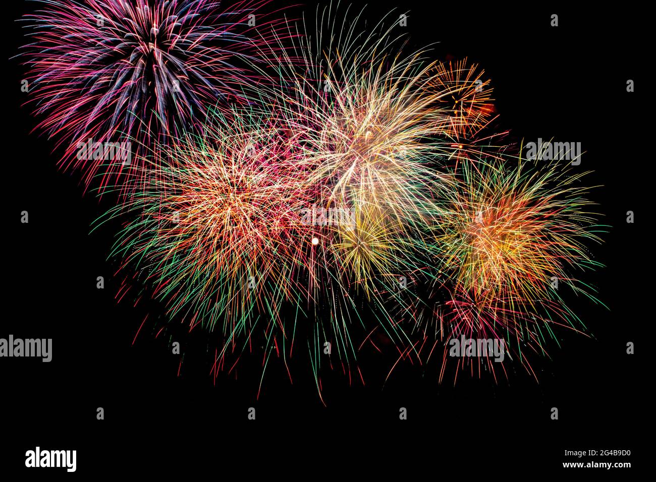 Colorful fireworks display surrounding a full moon in a dark night sky ...