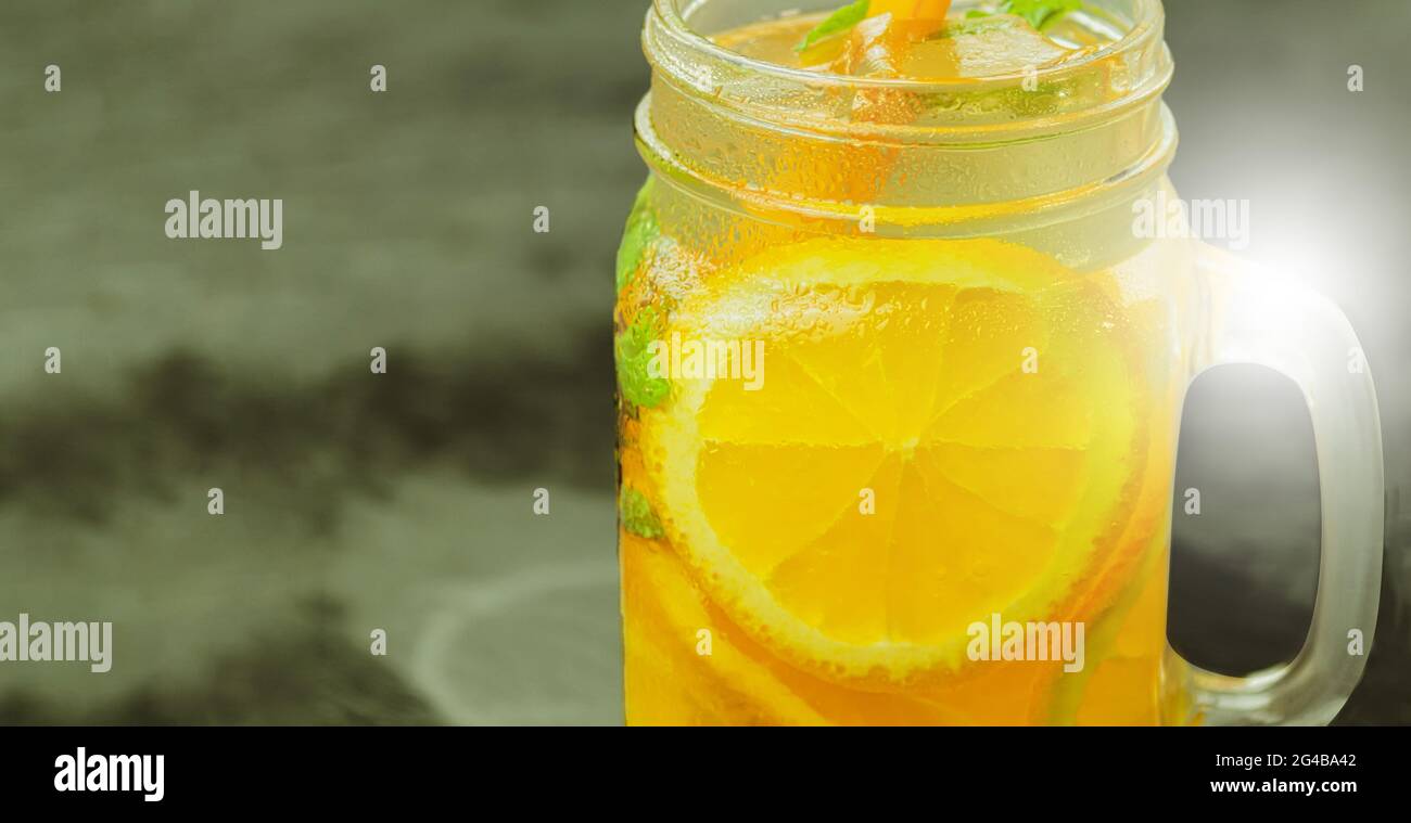 Cool lemonade made from orange and lime slices. Orange cocktail drink ...
