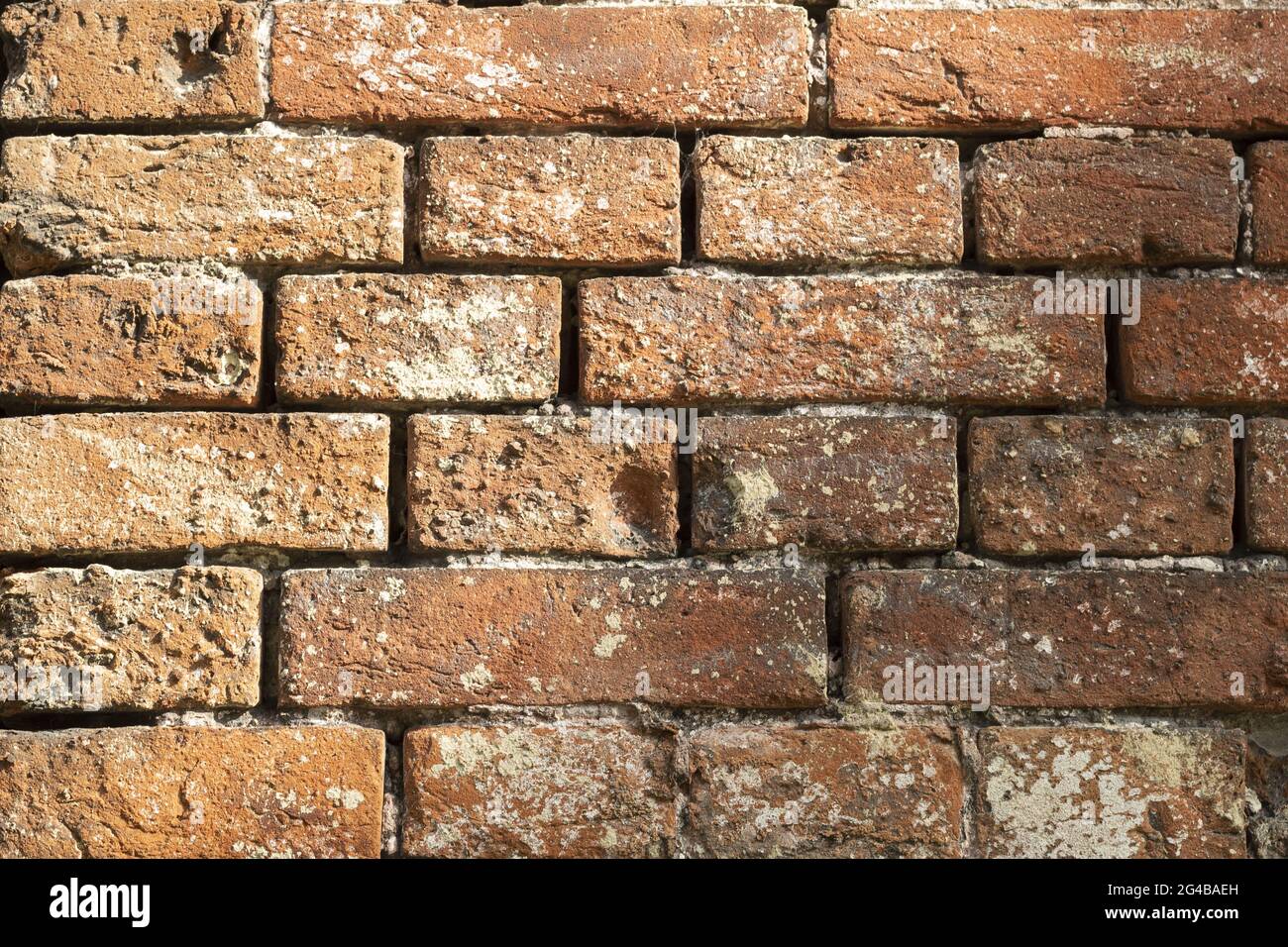 Textured red brick wall from old stones. Fragment of an old brick wall ...