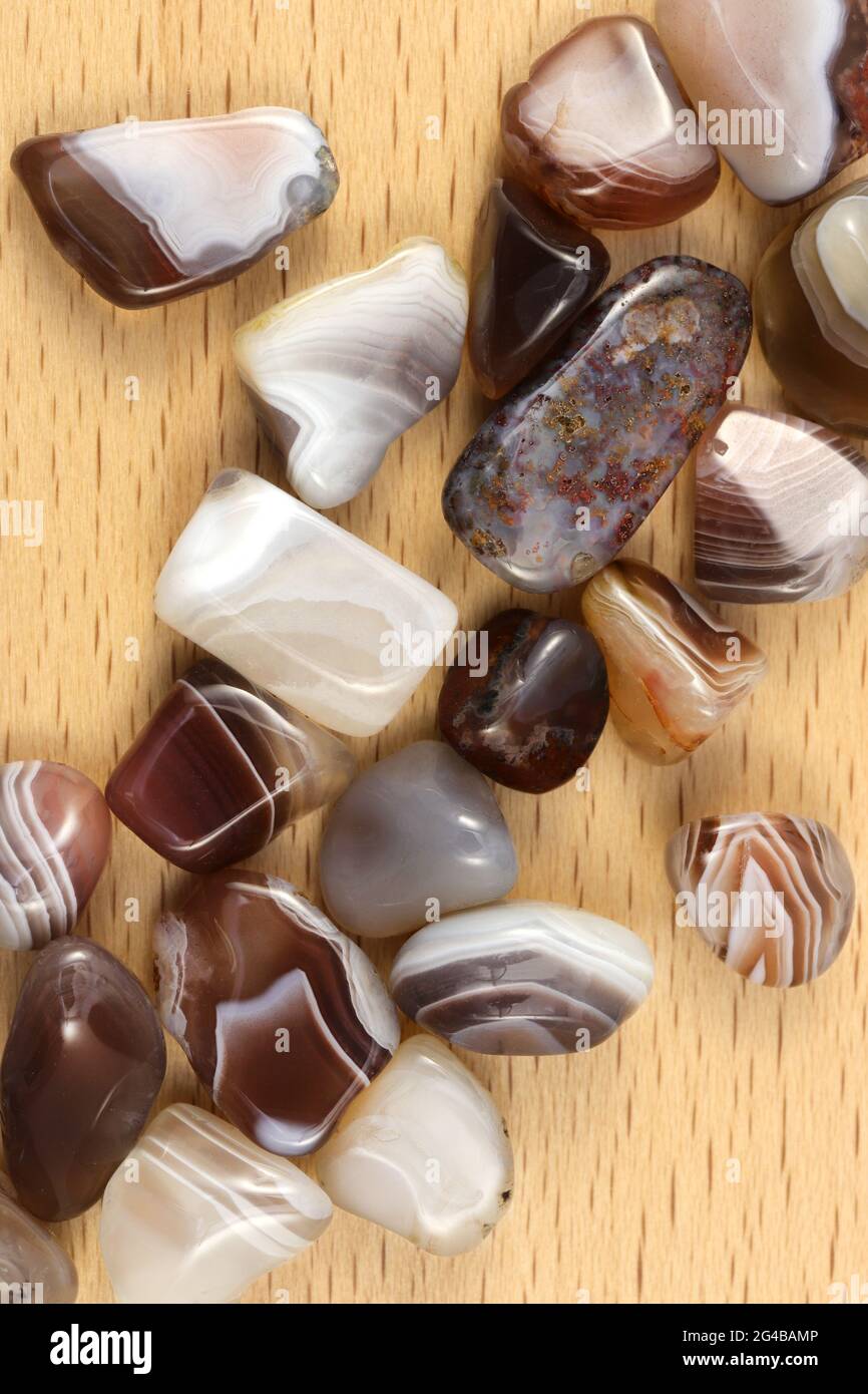 Persian agate heap up jewel stones texture on light varnished wood ...
