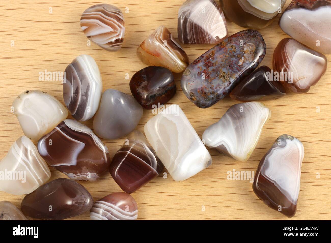 Persian agate heap up jewel stones texture on light varnished wood ...