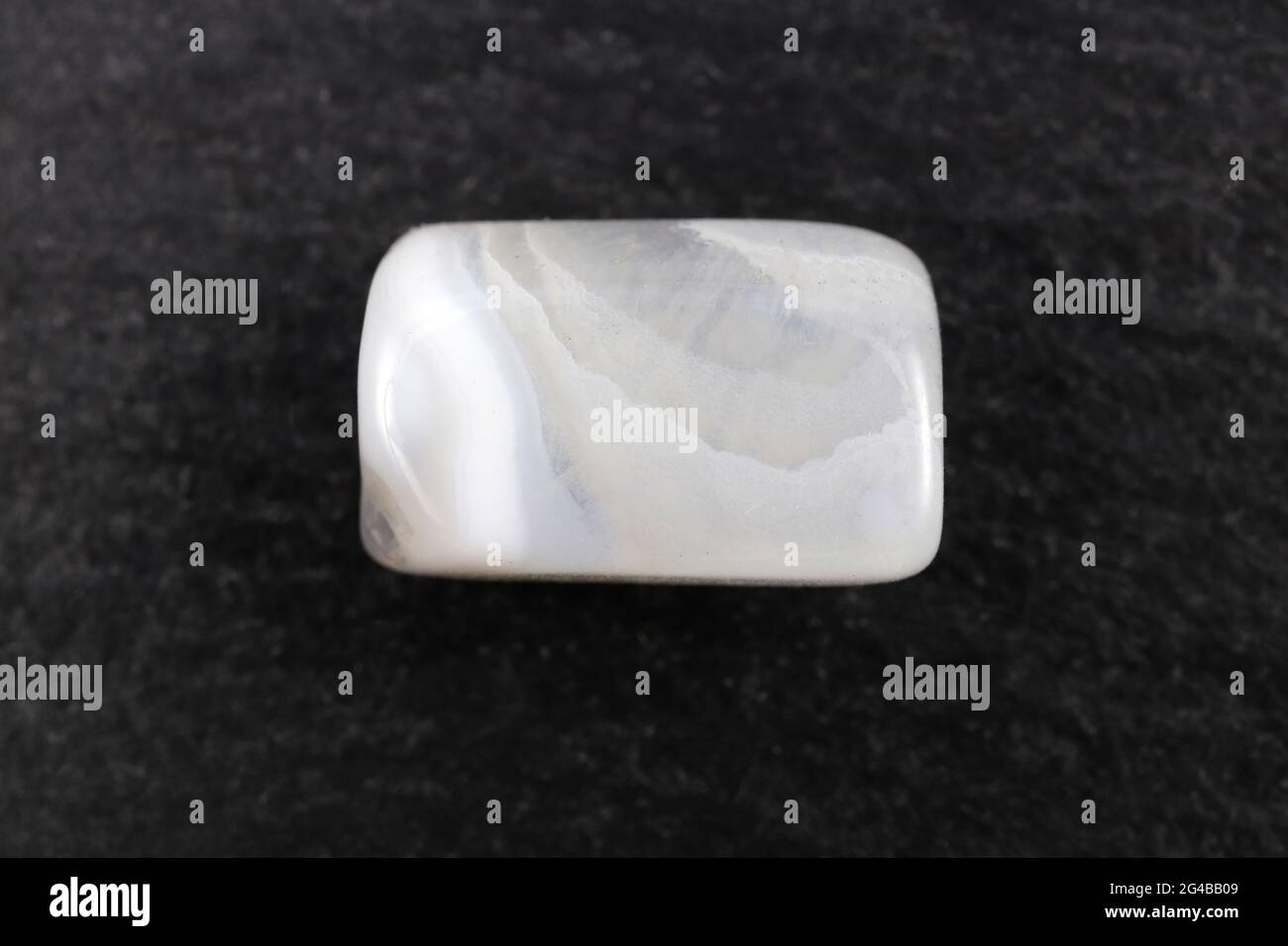 Persian agate jewel stone texture on black stone background. Macro ...