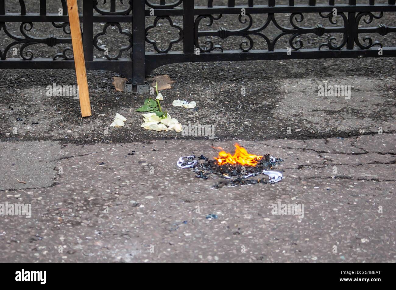 LONDON, ENGLAND- 15 May 2021: Burnt Israeli flag on the ground at a ...