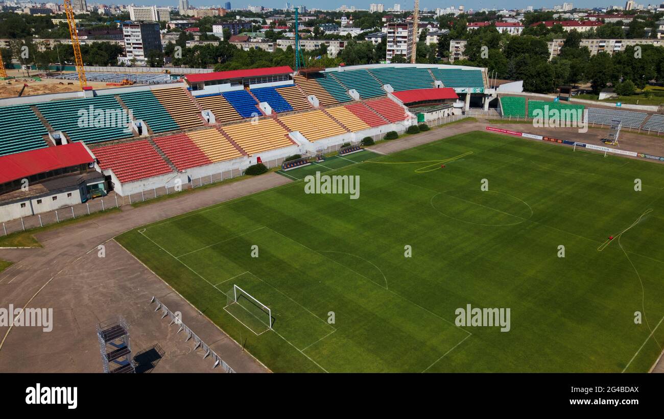 Football stadium in the city park. A green field and stands are visible ...