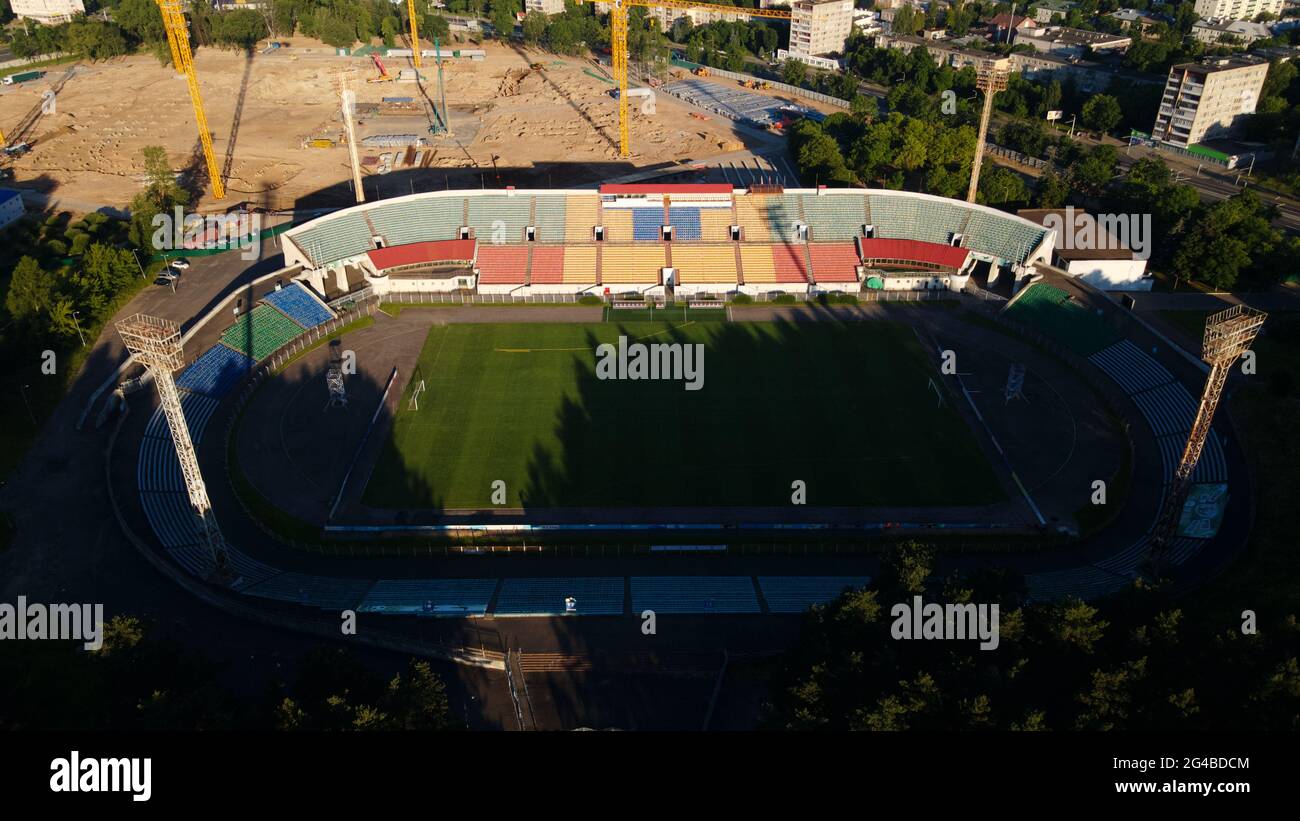 Football stadium in the city park. A new arena is being built nearby. A ...